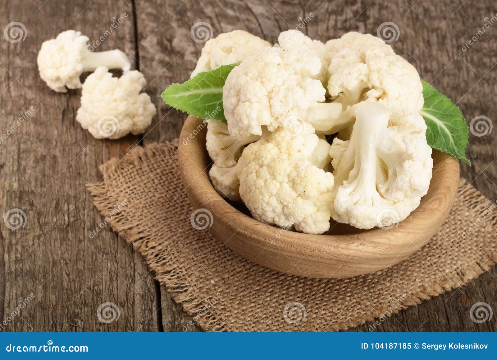 Fresh Cauliflower Cut into Small Pieces in Wooden Bowl on Rustic ...