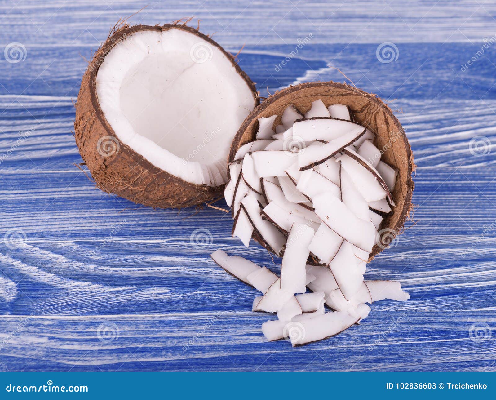 Coconut Pieces in Bowl on Blue Background. Fresh Coconut Slices Stock ...