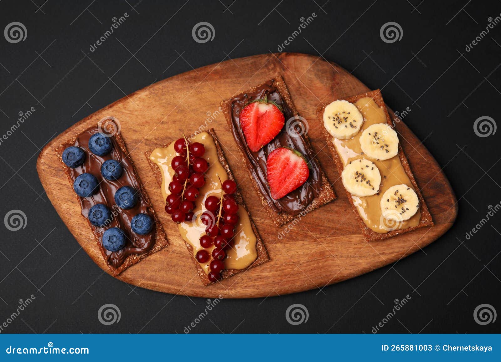 Fresh Crunchy Rye Crispbreads with Different Toppings on Black Table ...