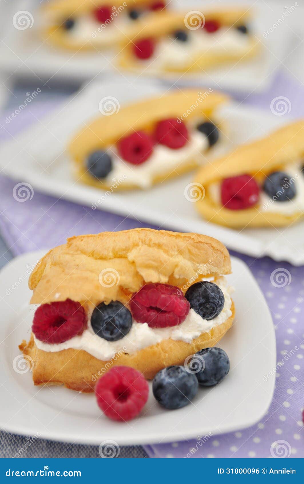 Fresh Eclairs with Whipped Cream and Berries Stock Photo - Image of ...
