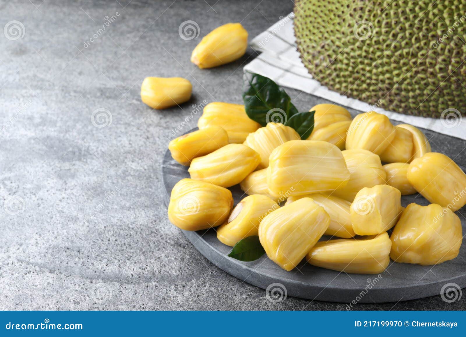Fresh Exotic Jackfruit Bulbs on Grey Table. Space for Text Stock Photo ...