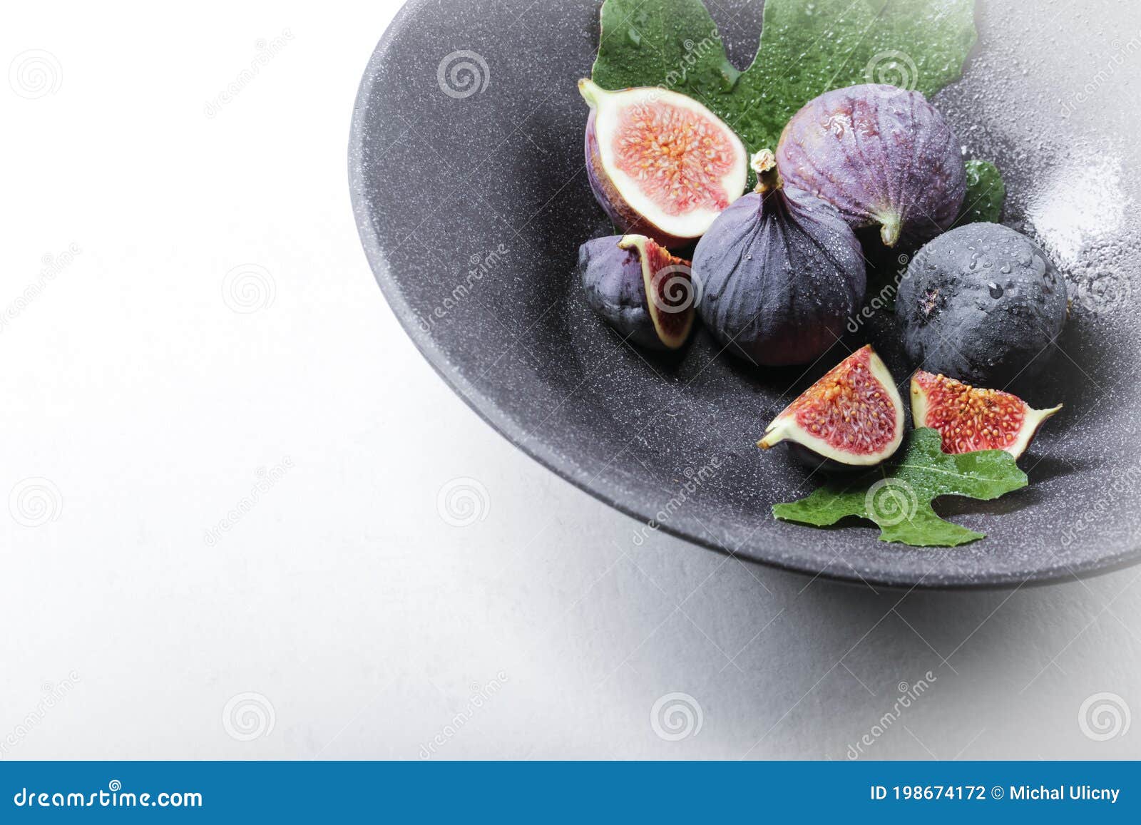 Fresh Figs with Green Leafs on the Very Nice Dark Plate. White ...