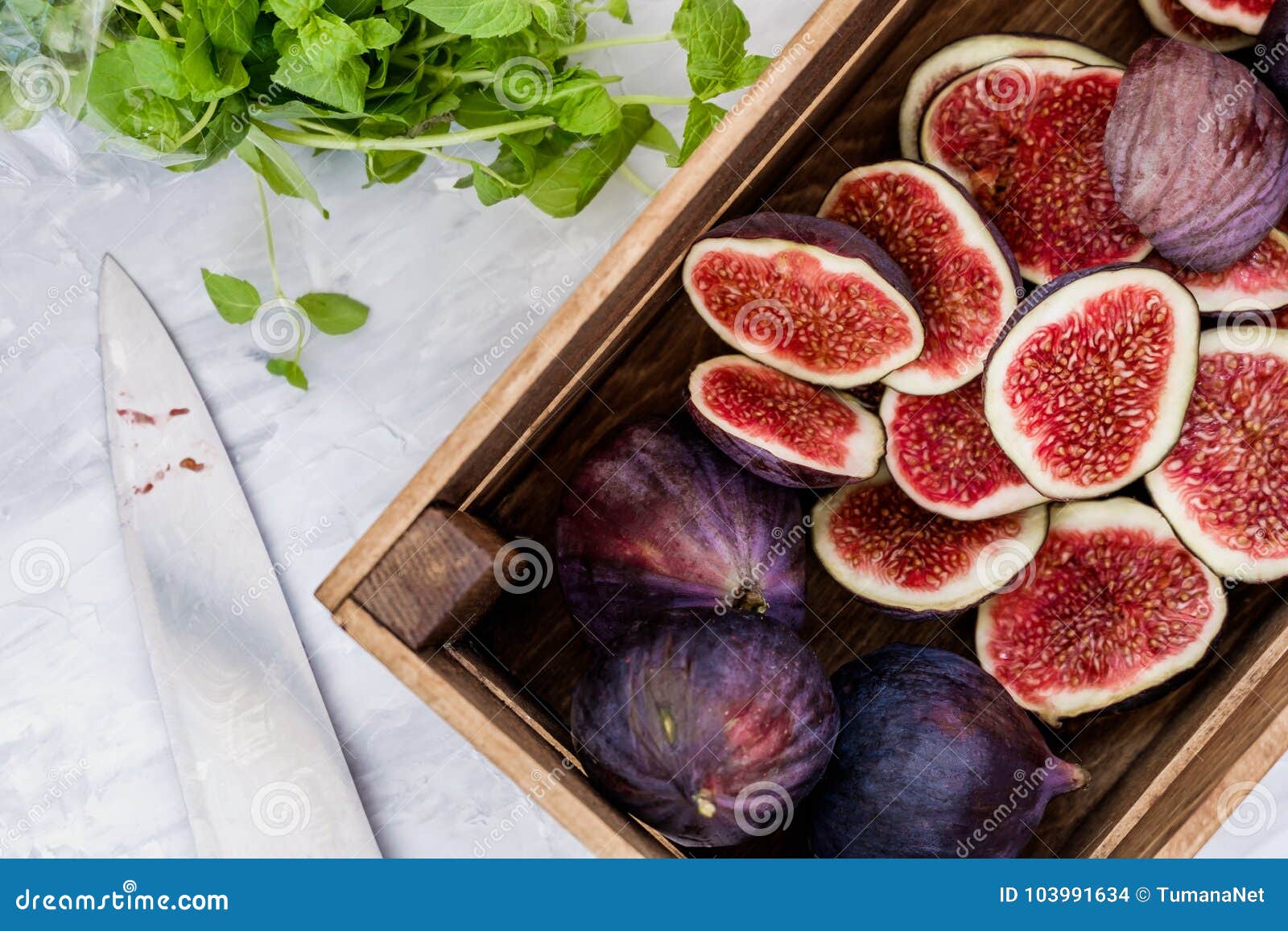 Fresh Figs in a Wooden Box with Mint on a Textured Concrete Gray ...