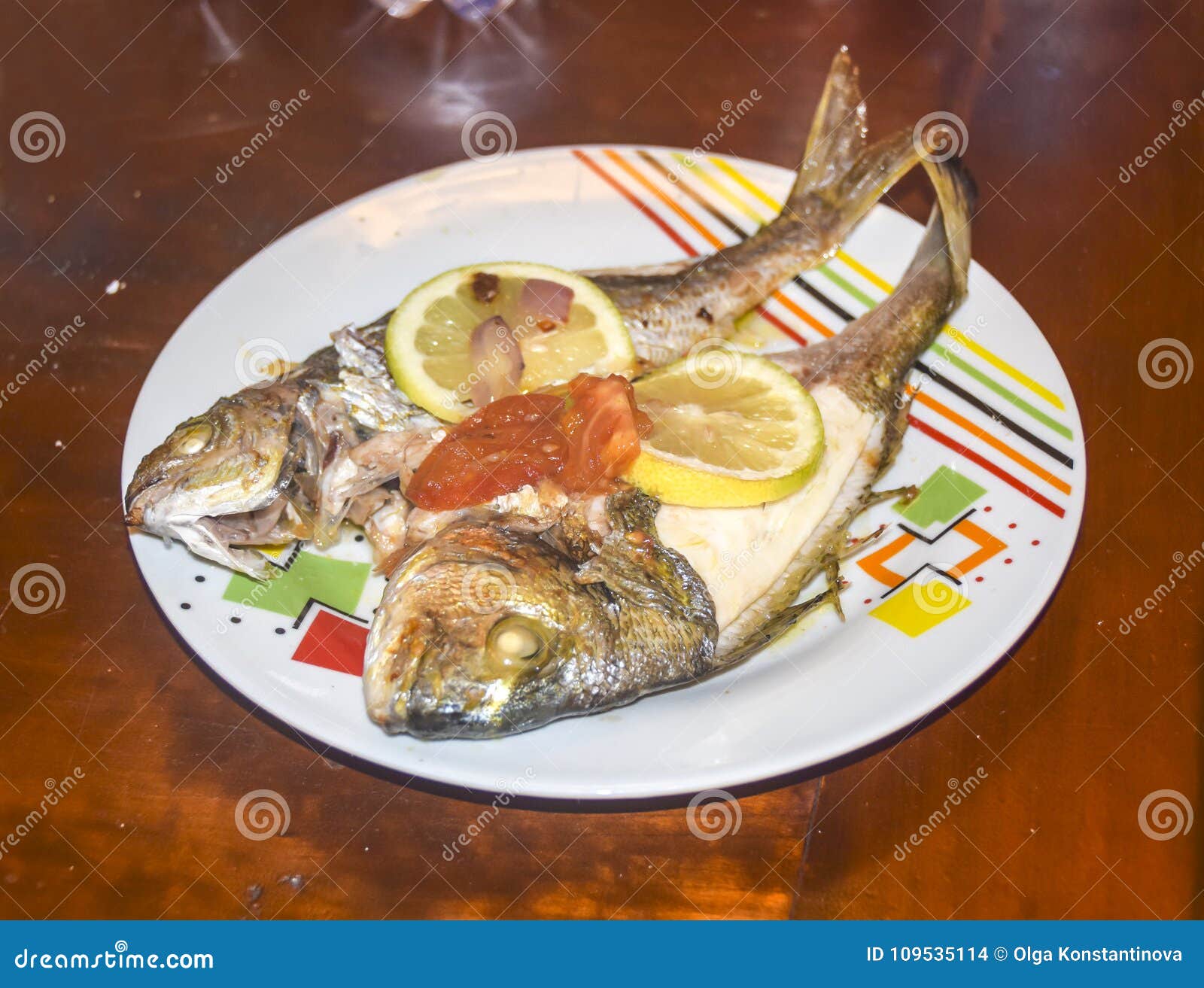 Fresh Fried Baked Fish with Scales and Lemon in a Plate Stock Photo ...