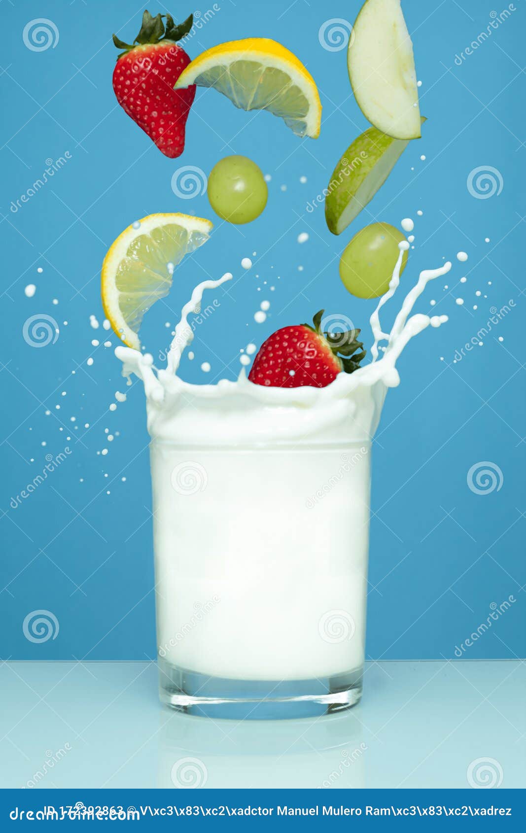 Fresh Fruit Falling into a Glass of Milk and Causing a Splash Stock ...