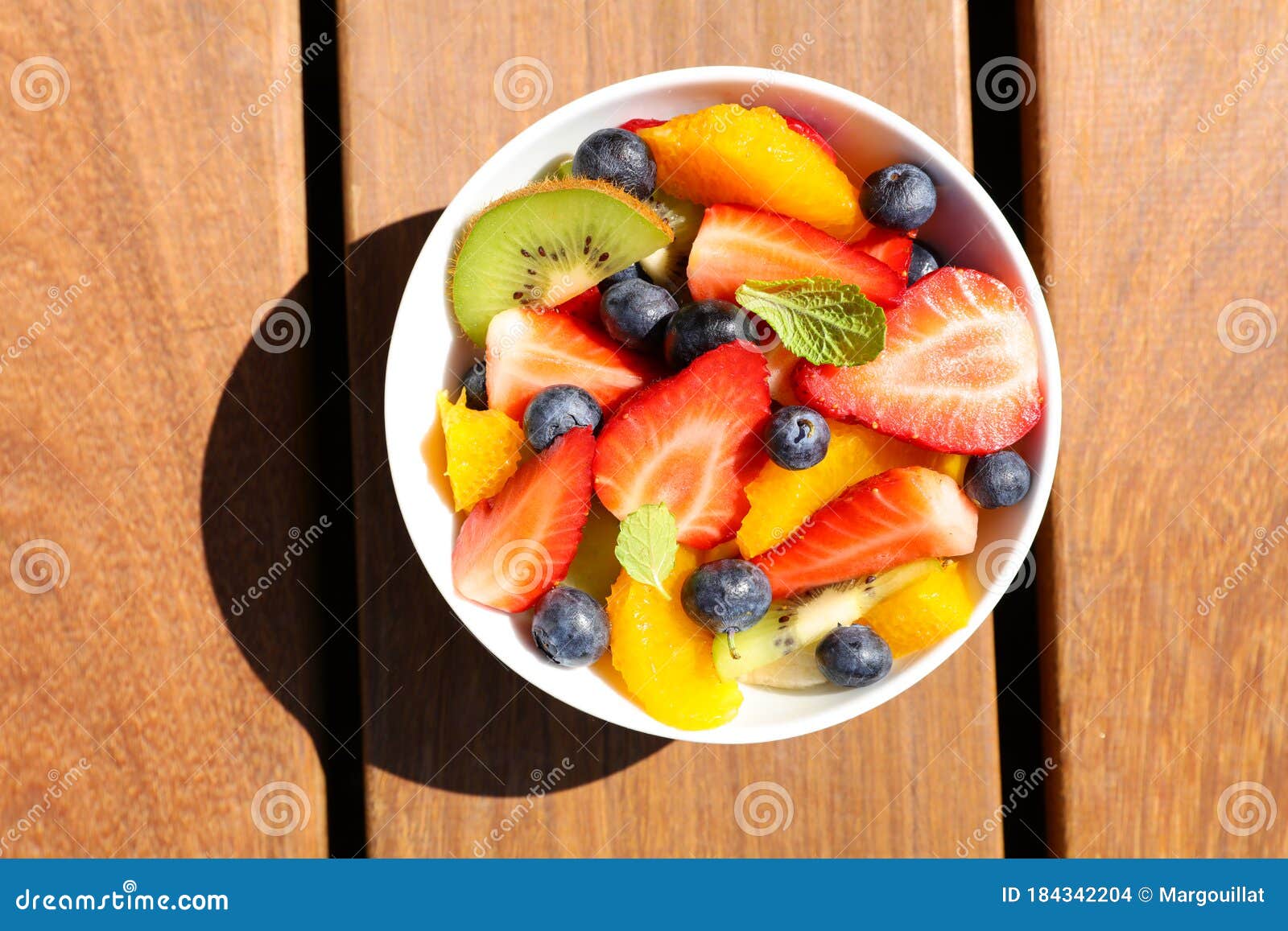 Fresh fruit salad in bowl stock photo. Image of food - 184342204