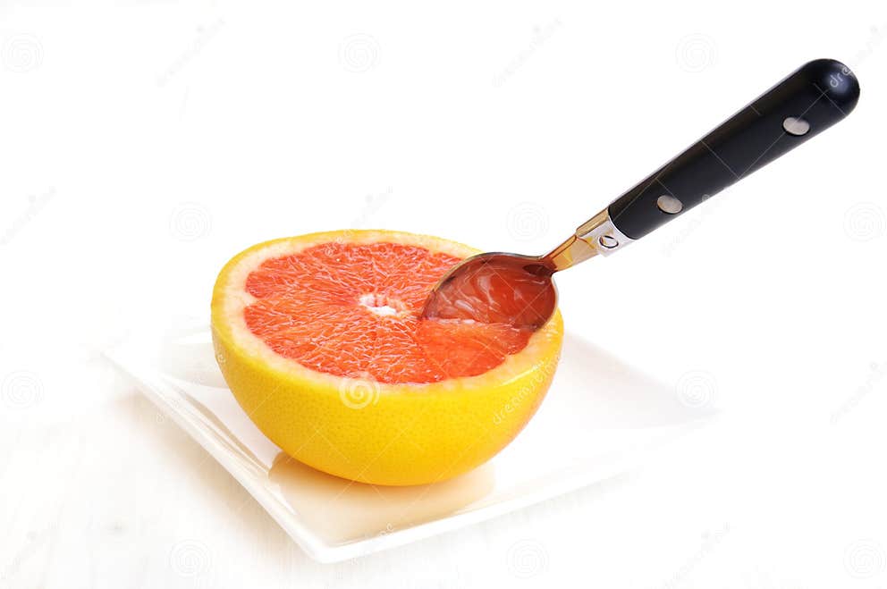 Fresh grapefruit and spoon stock image. Image of citrus - 8365219