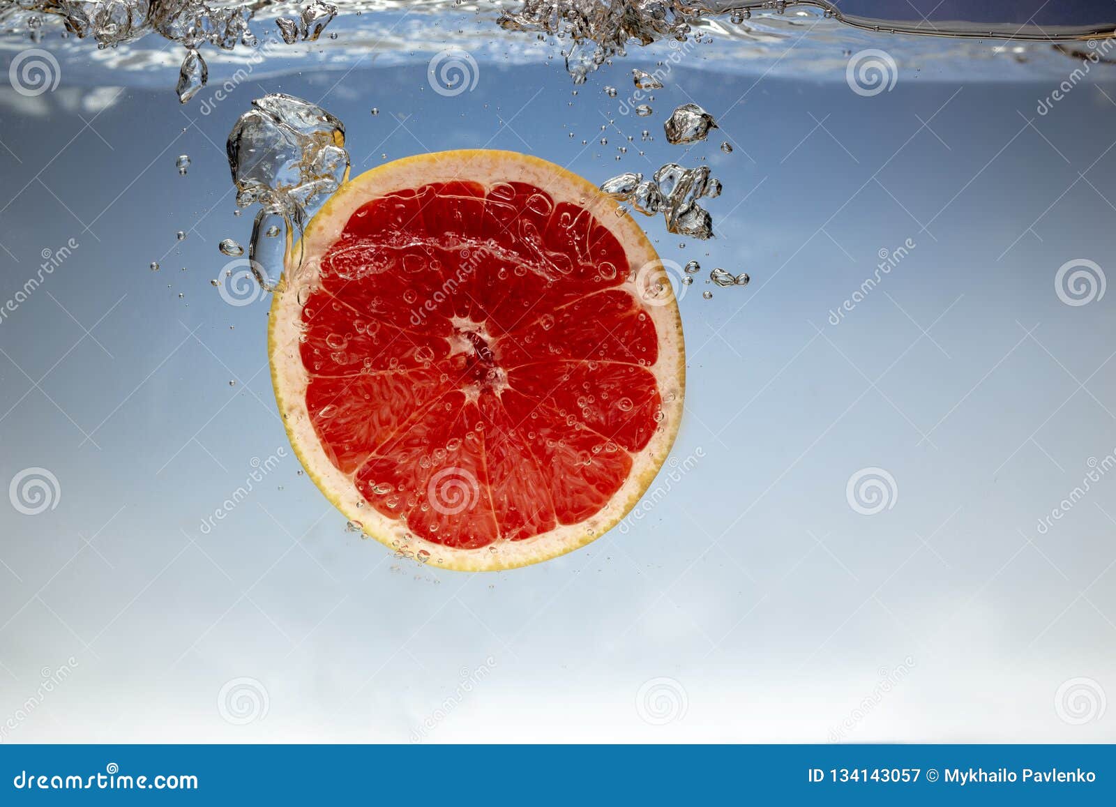 Fresh Grapefruit with Water Splash on Blue Background Close Up Stock ...