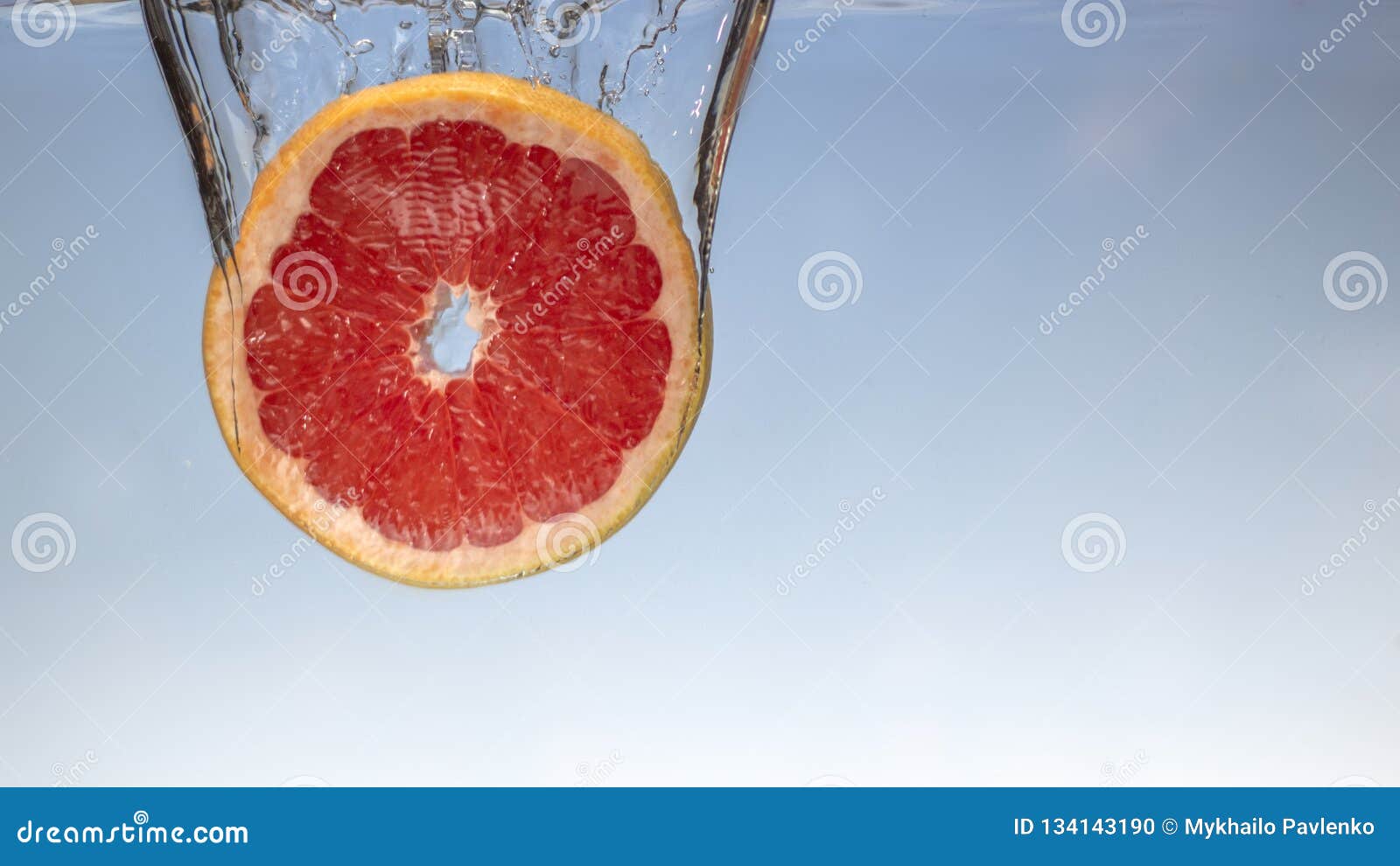 Fresh Grapefruit with Water Splash on Blue Background Close Up Stock ...