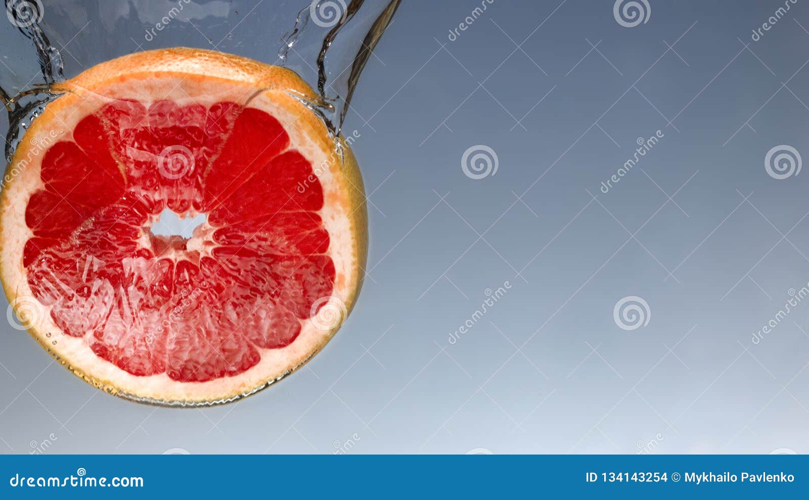 Fresh Grapefruit with Water Splash on Blue Background Close Up Stock ...