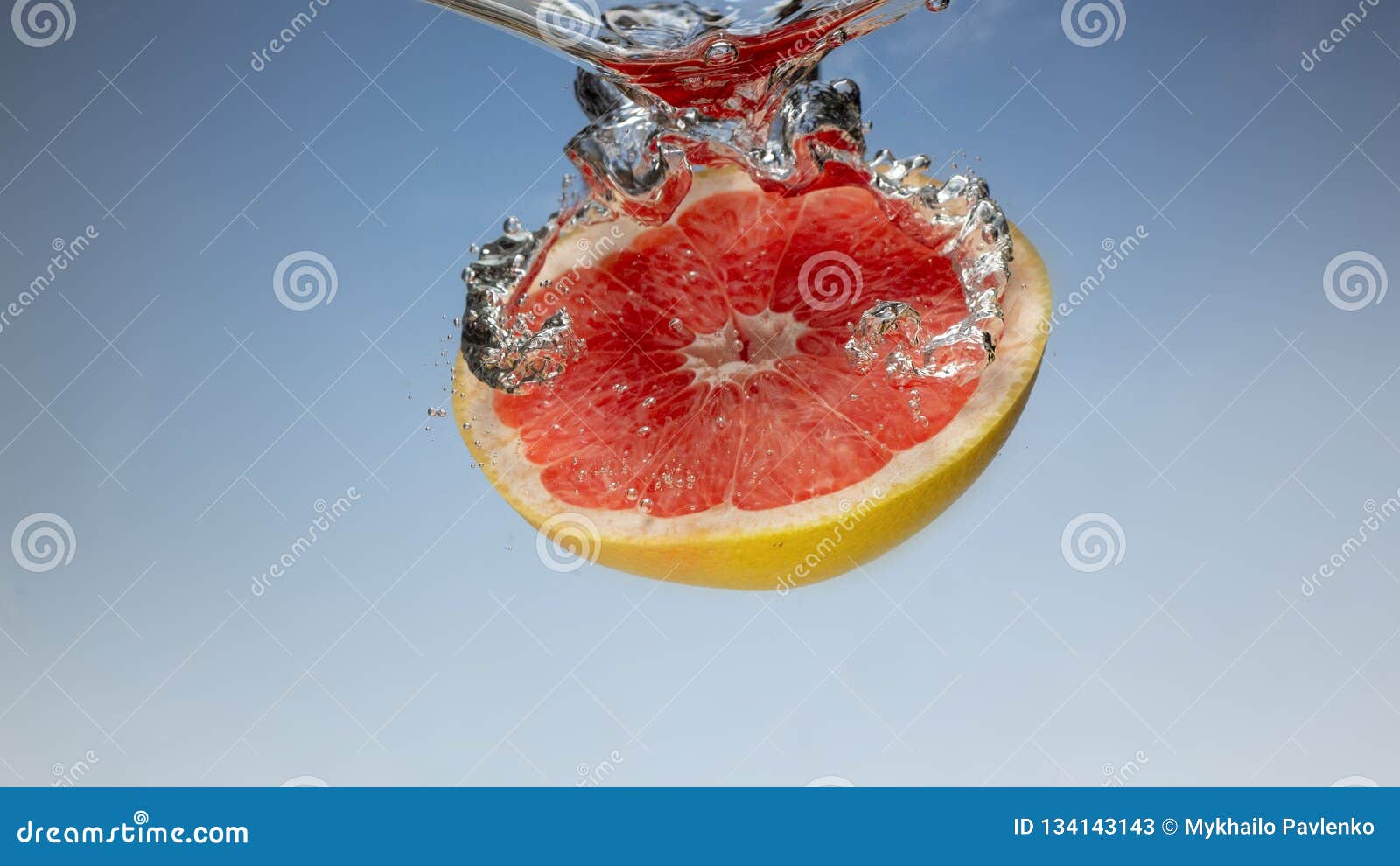 Fresh Grapefruit with Water Splash on Blue Background Close Up Stock ...