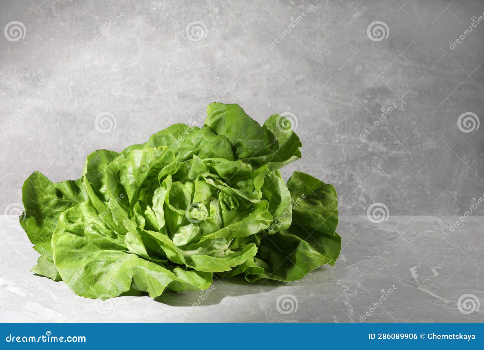 Fresh Green Butter Lettuce on Grey Marble Table, Space for Text Stock ...