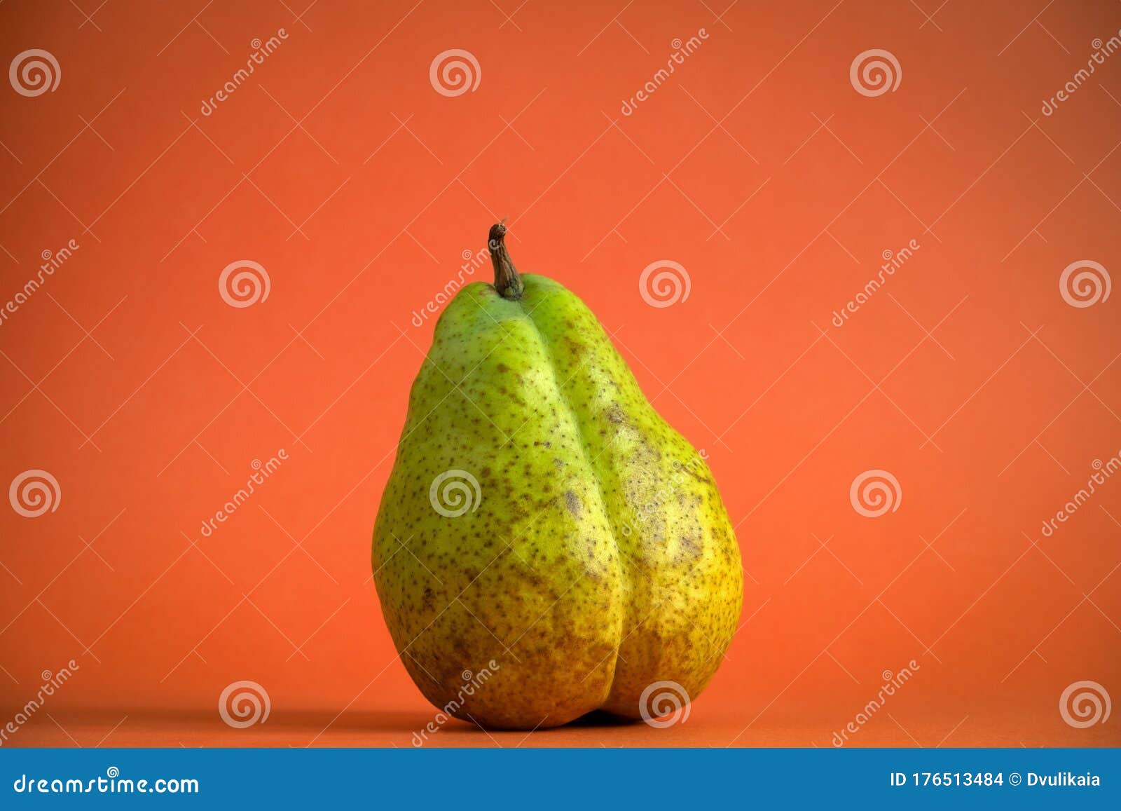 Green Pear In The Shape Of A Female Figure On Orange Background Stock ...