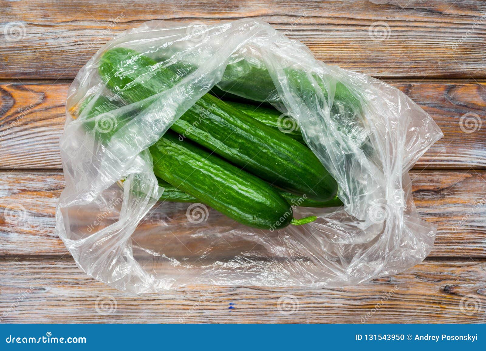 Cucumbers in Plastic Packaging on a Wooden Table Stock Photo - Image of ...