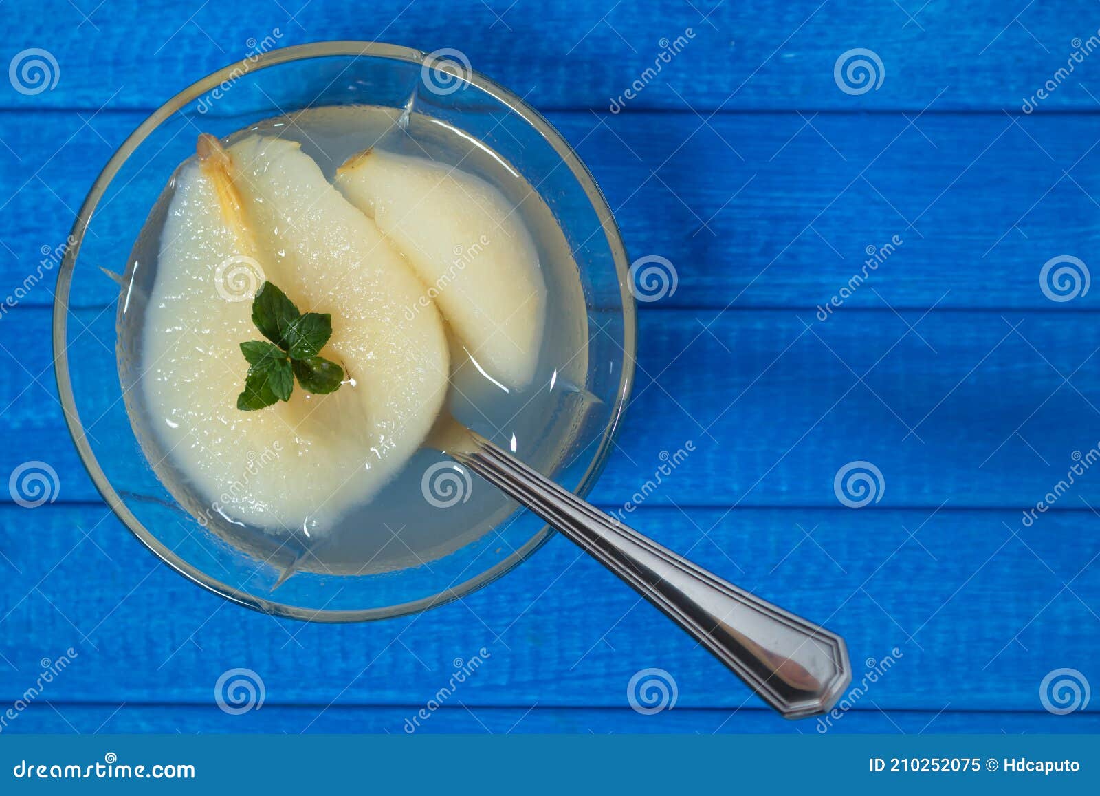 Fresh Half Pears Served with Sweet Syrup and Mint Leaves. Blue ...
