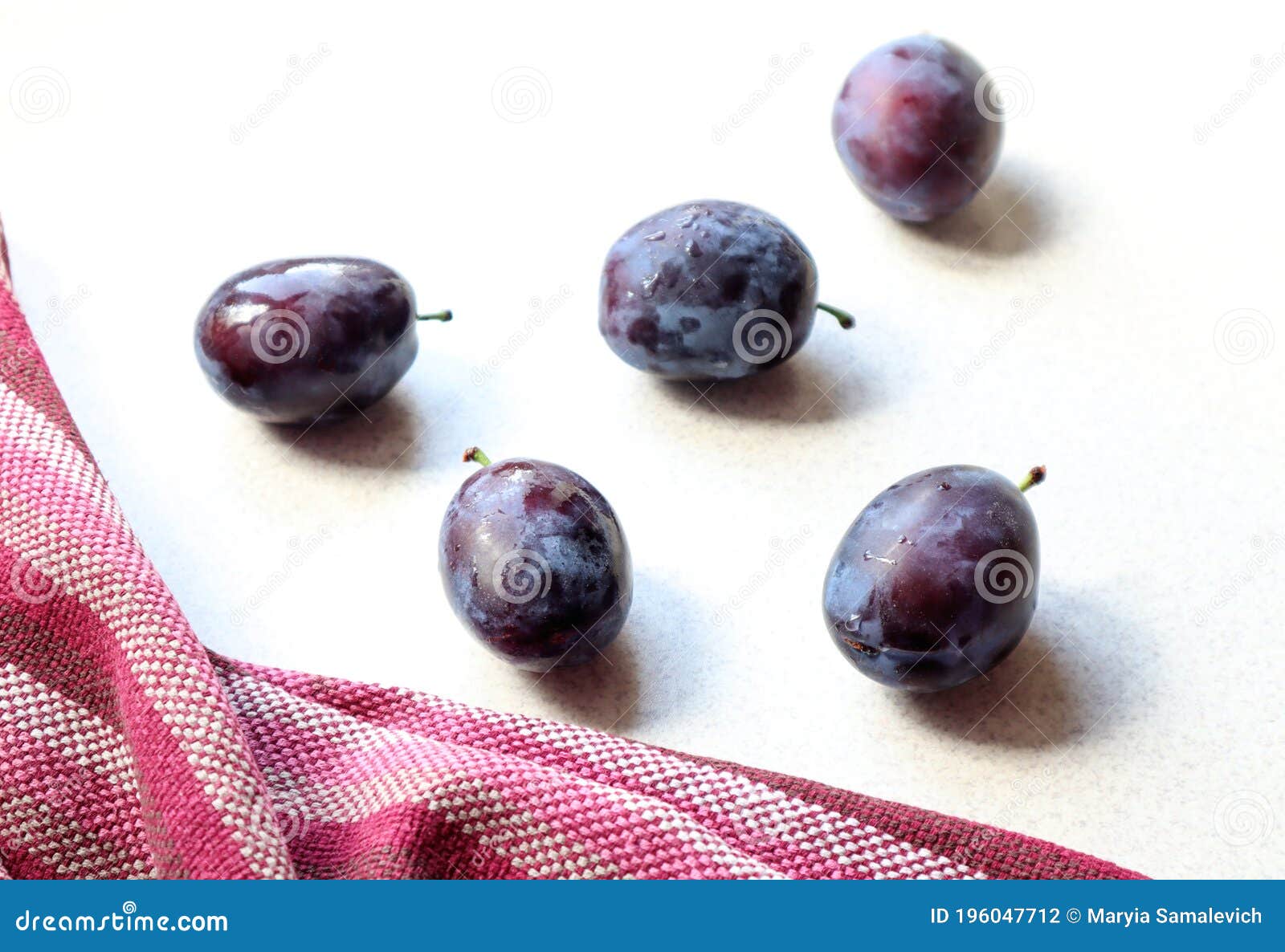 Fresh Large Plums on a Gray Surface with a Kitchen Napkin, Side View ...