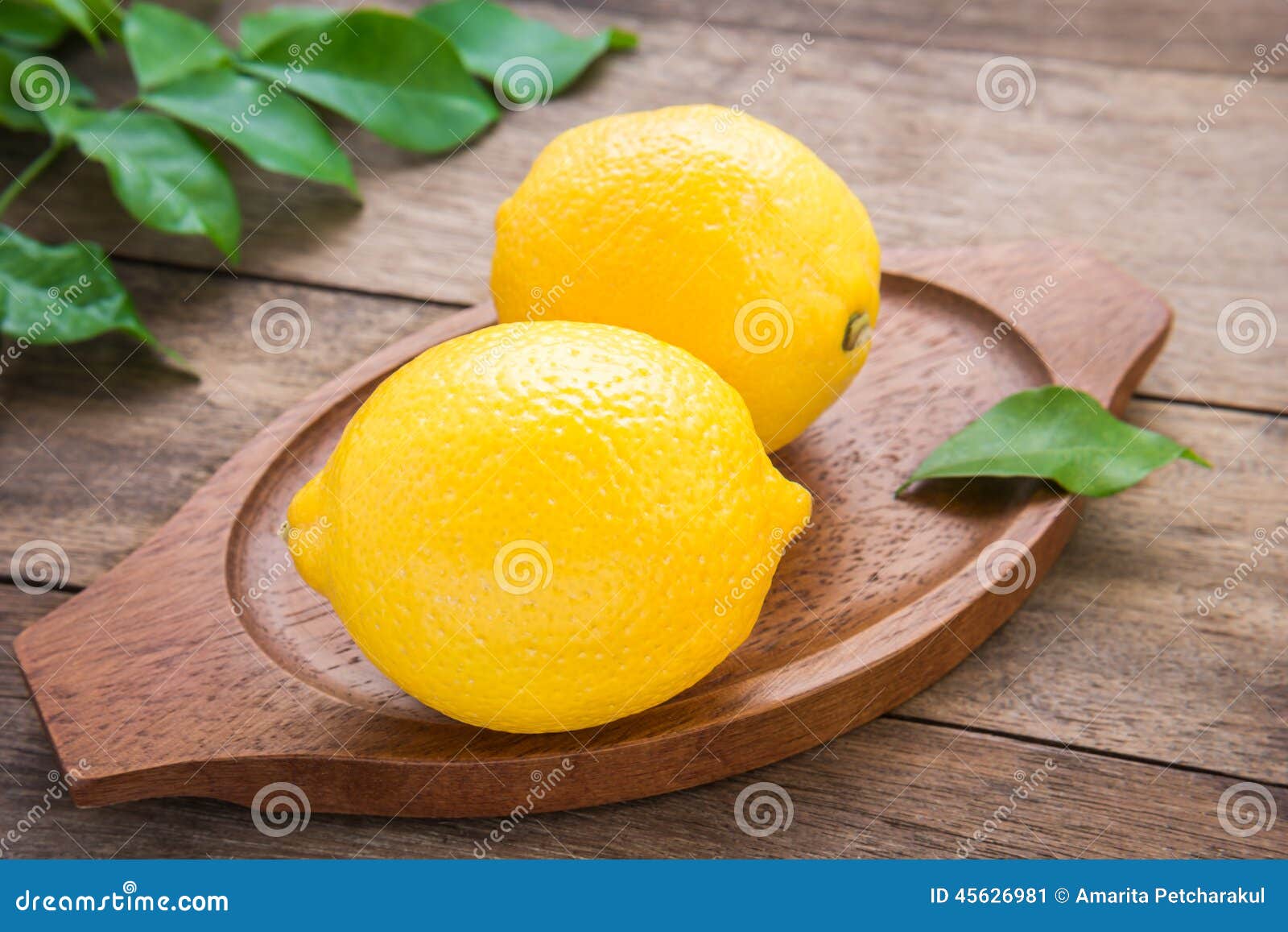 Fresh Lemons on Wooden Plate Stock Image - Image of delicious, wooden ...