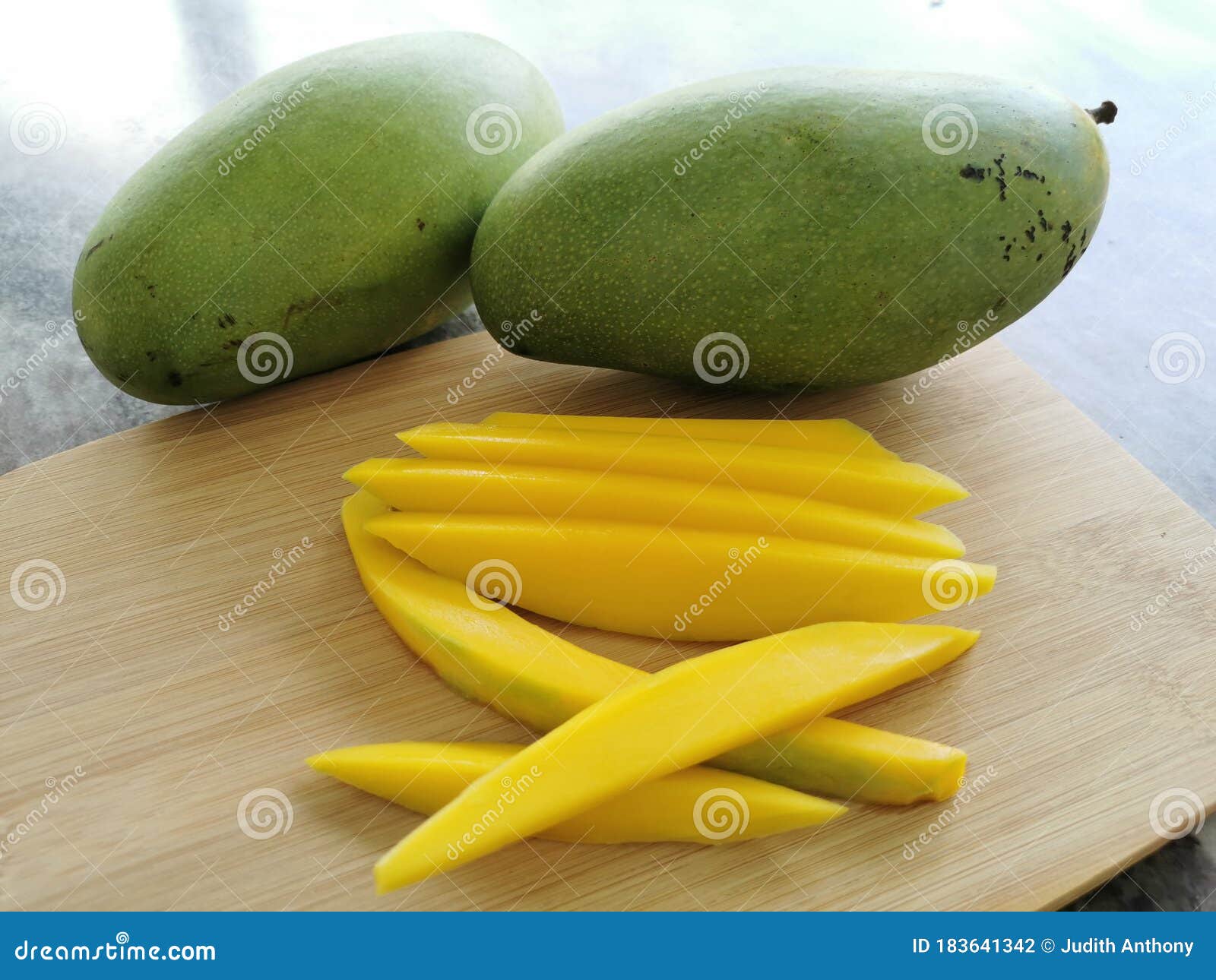 Fresh Mango Fruits with Slices on Chopping Board. Stock Photo - Image ...