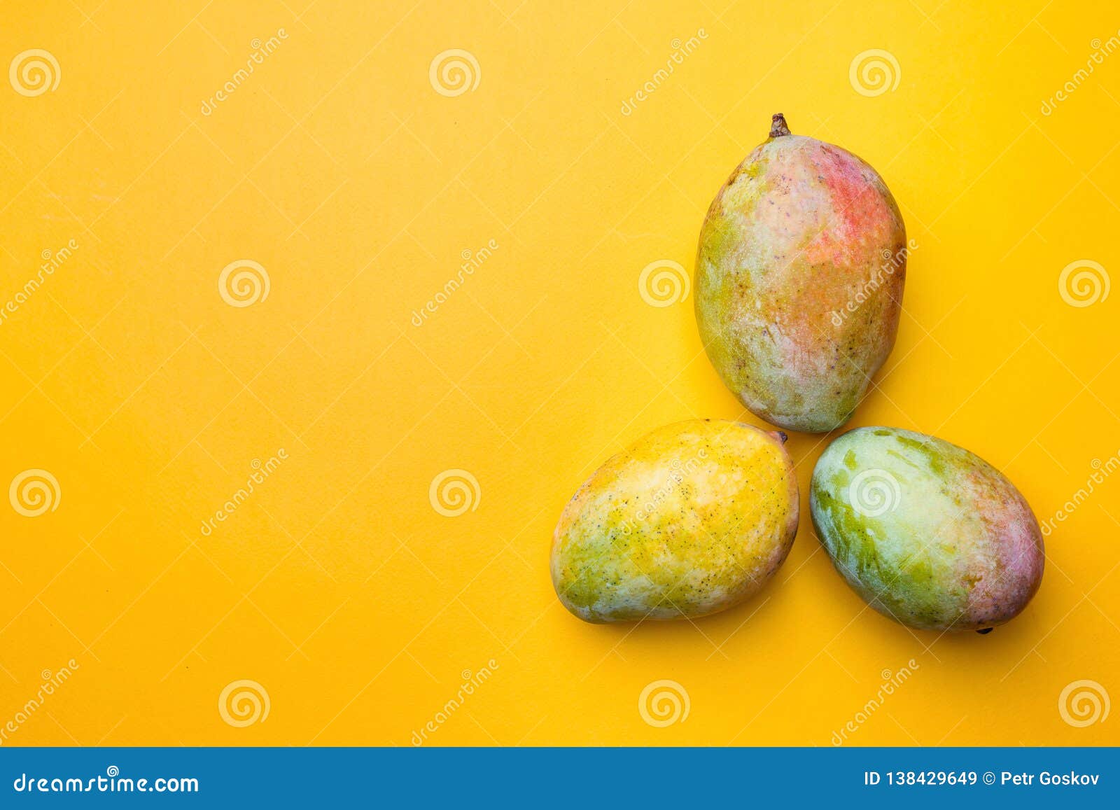 Fresh mango on yellow stock image. Image of background - 138429649