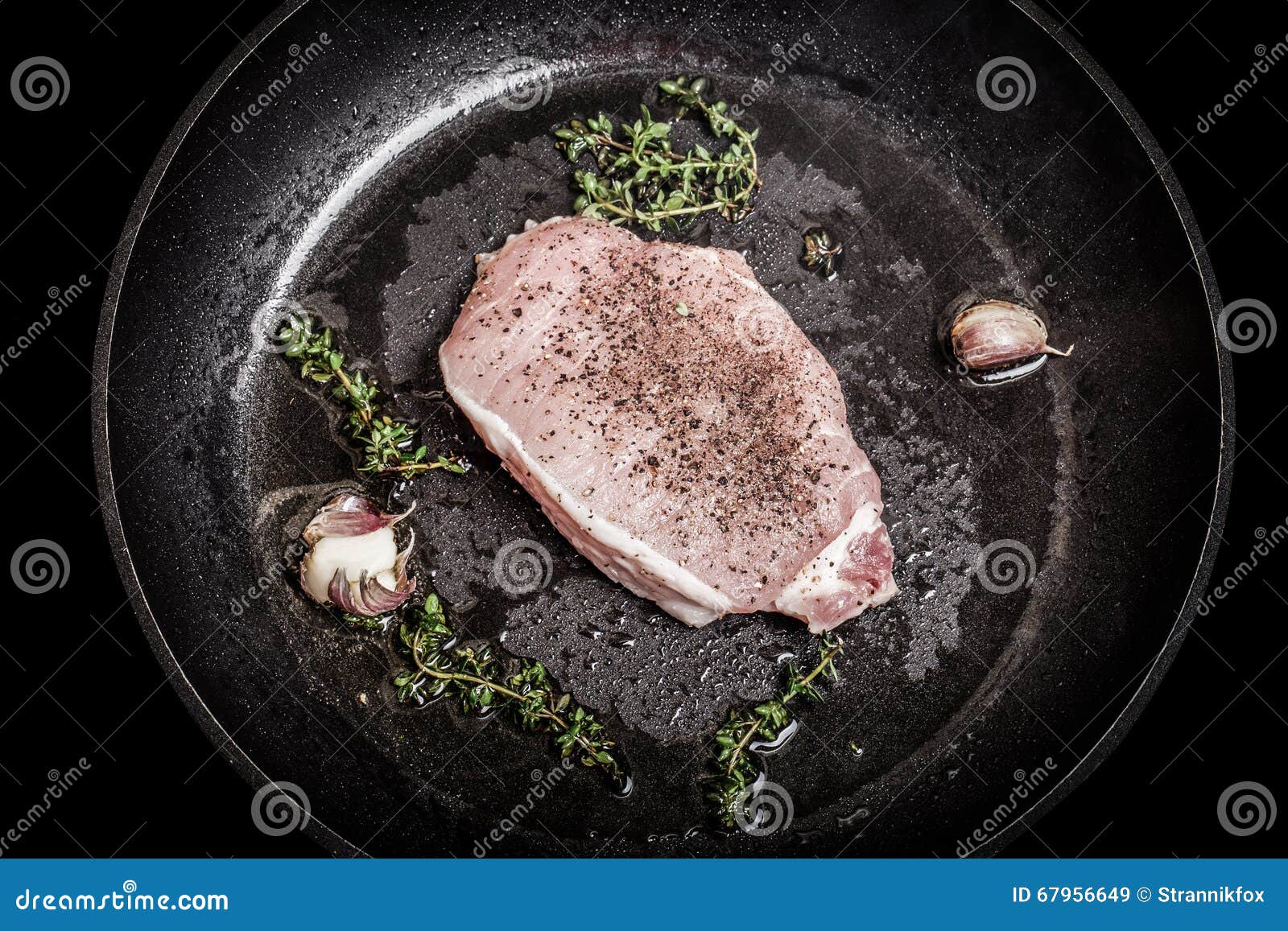 Fresh Meat is Fried in a Frying Pan with Thyme and Garlic. Toned Stock ...
