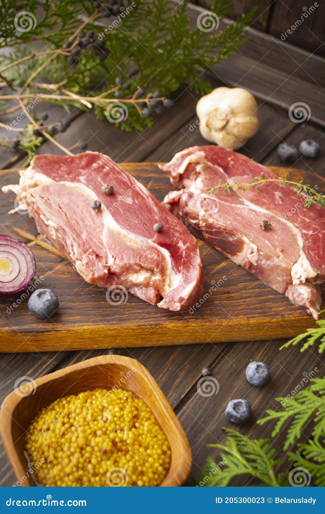 Fresh Meat of Wild Boar on the Board for Cutting with Blueberries and a ...