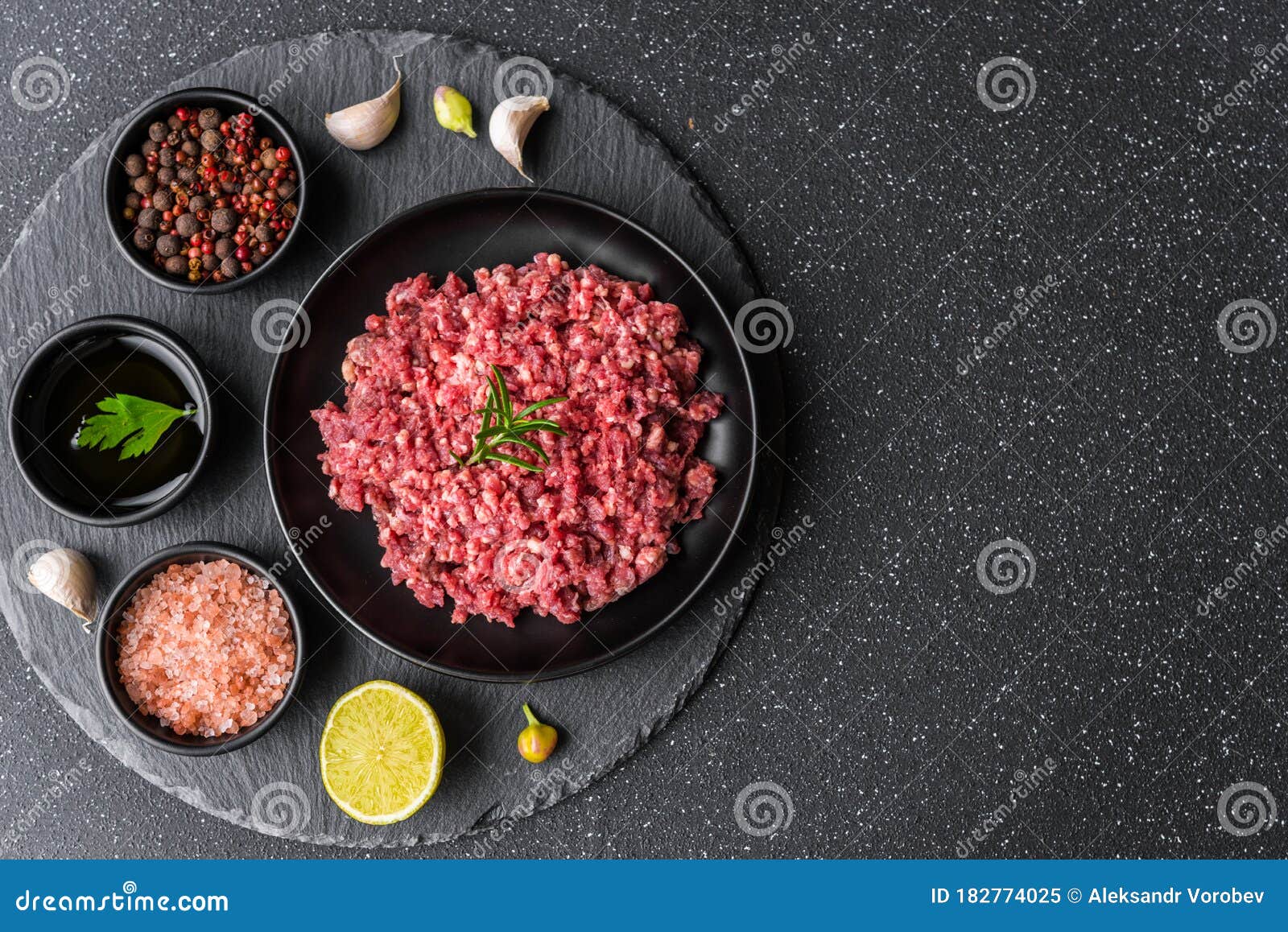 Fresh Minced Meat Ground Beef on a Black Plate Against Stone Background ...