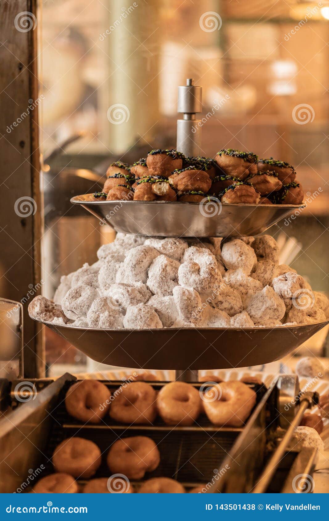 Fresh Mini Donuts on Display Stock Photo - Image of frosted, metal ...