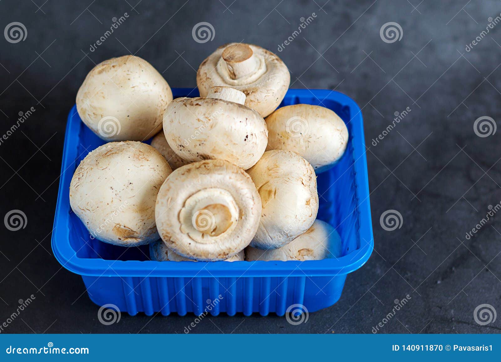 Fresh Mushrooms in Blue Plastic Box on Grey Background Stock Photo ...