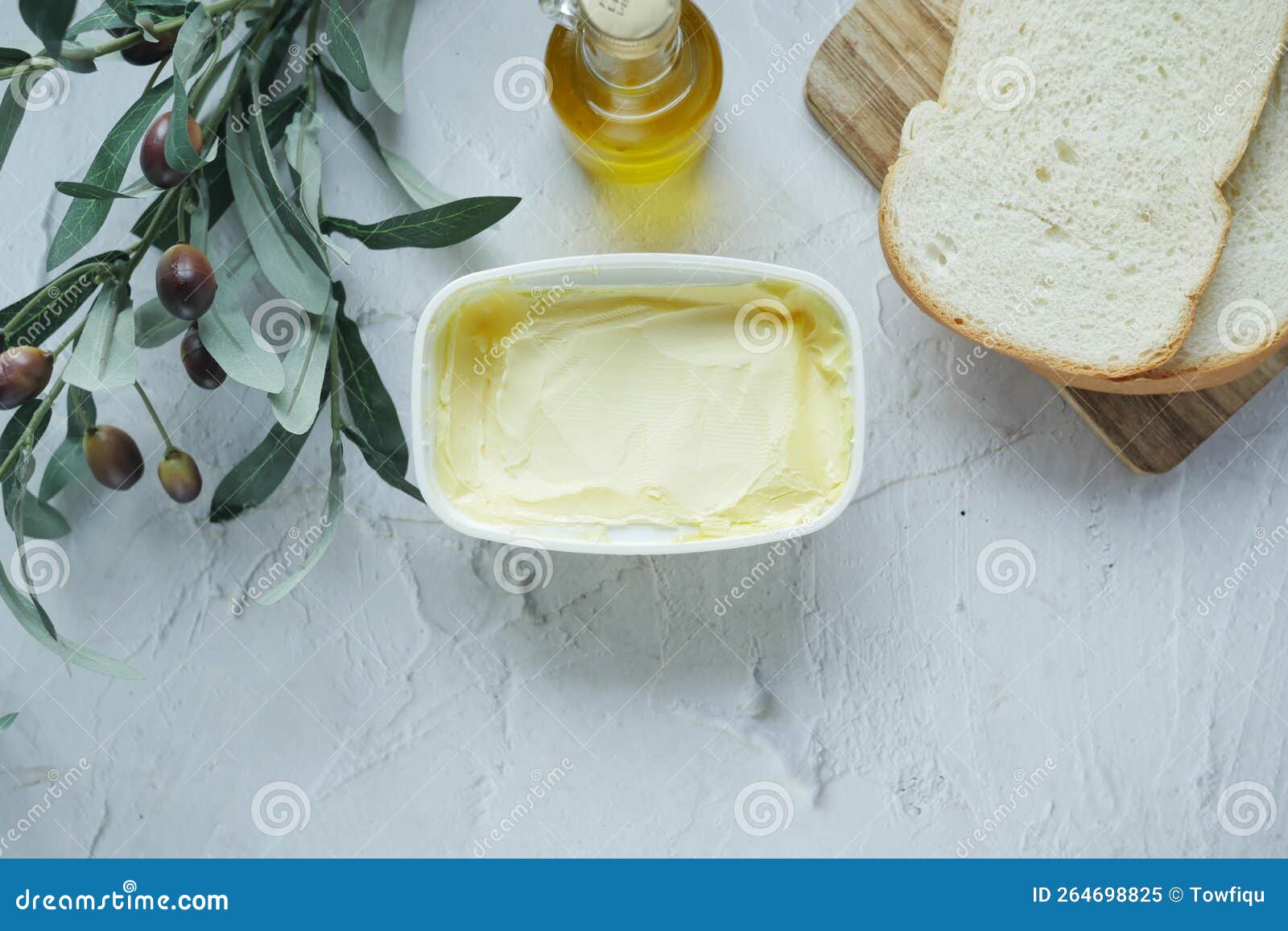 Fresh Olive Butter in a Container with Bread on White Background Stock ...