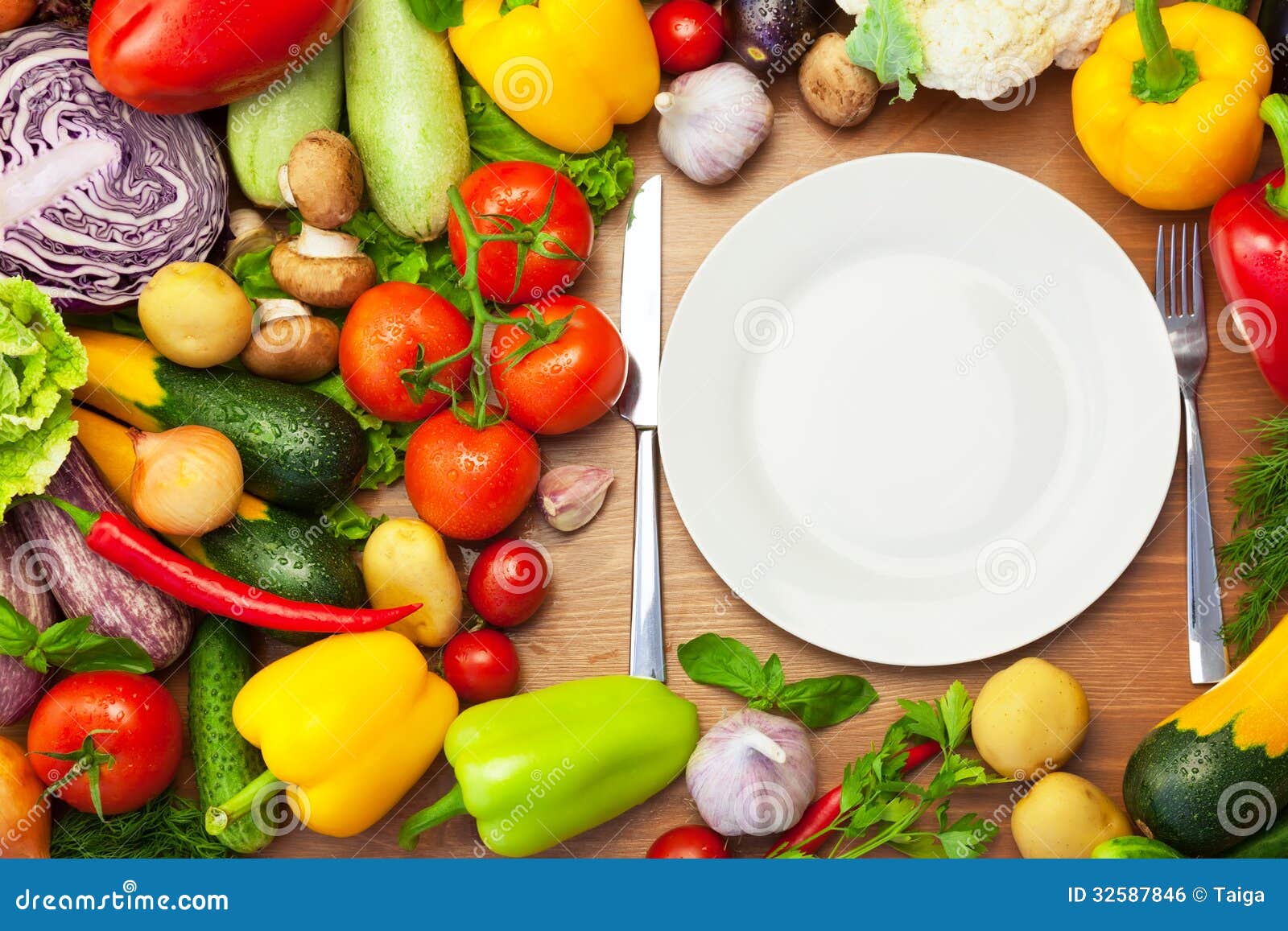 Fresh Organic Vegetables Around White Plate with Knife and Fork Stock ...