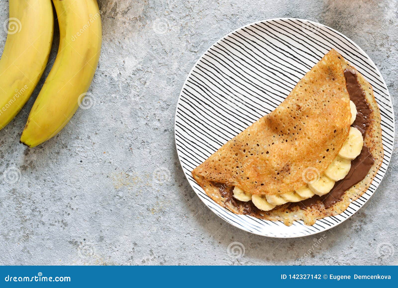 Fresh Pancakes with Chocolate Paste and Bananas on a Concrete ...
