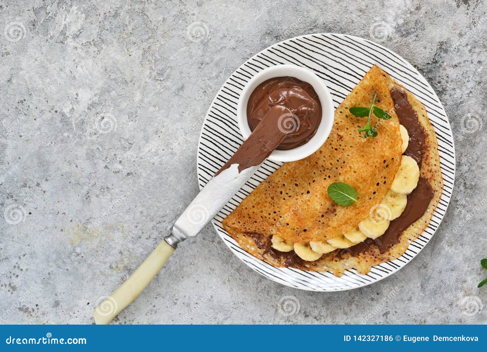 Fresh Pancakes with Chocolate Paste and Bananas on a Concrete ...