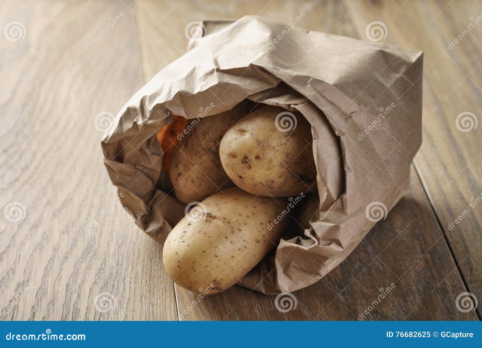 Fresh Potatoes in Kraft Paper Bag on Oak Table Stock Image - Image of ...