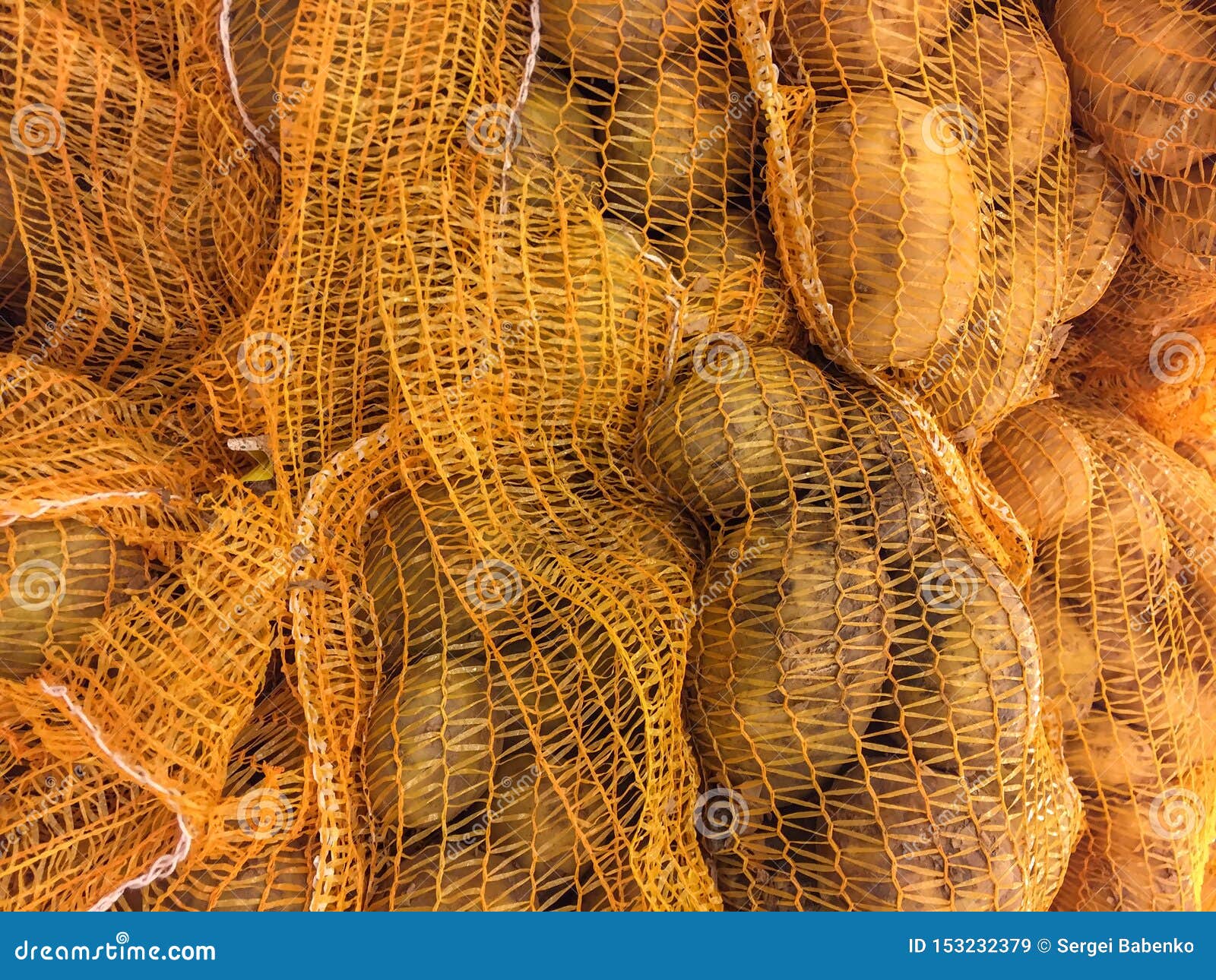 Fresh Potatoes in the Package in the Form of a Yellow Grid Stock Image ...