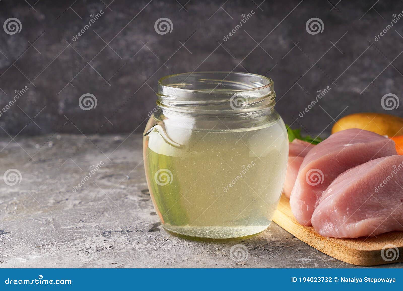 Fresh Poultry Broth in a Glass Jar on a Table with Vegetables and ...