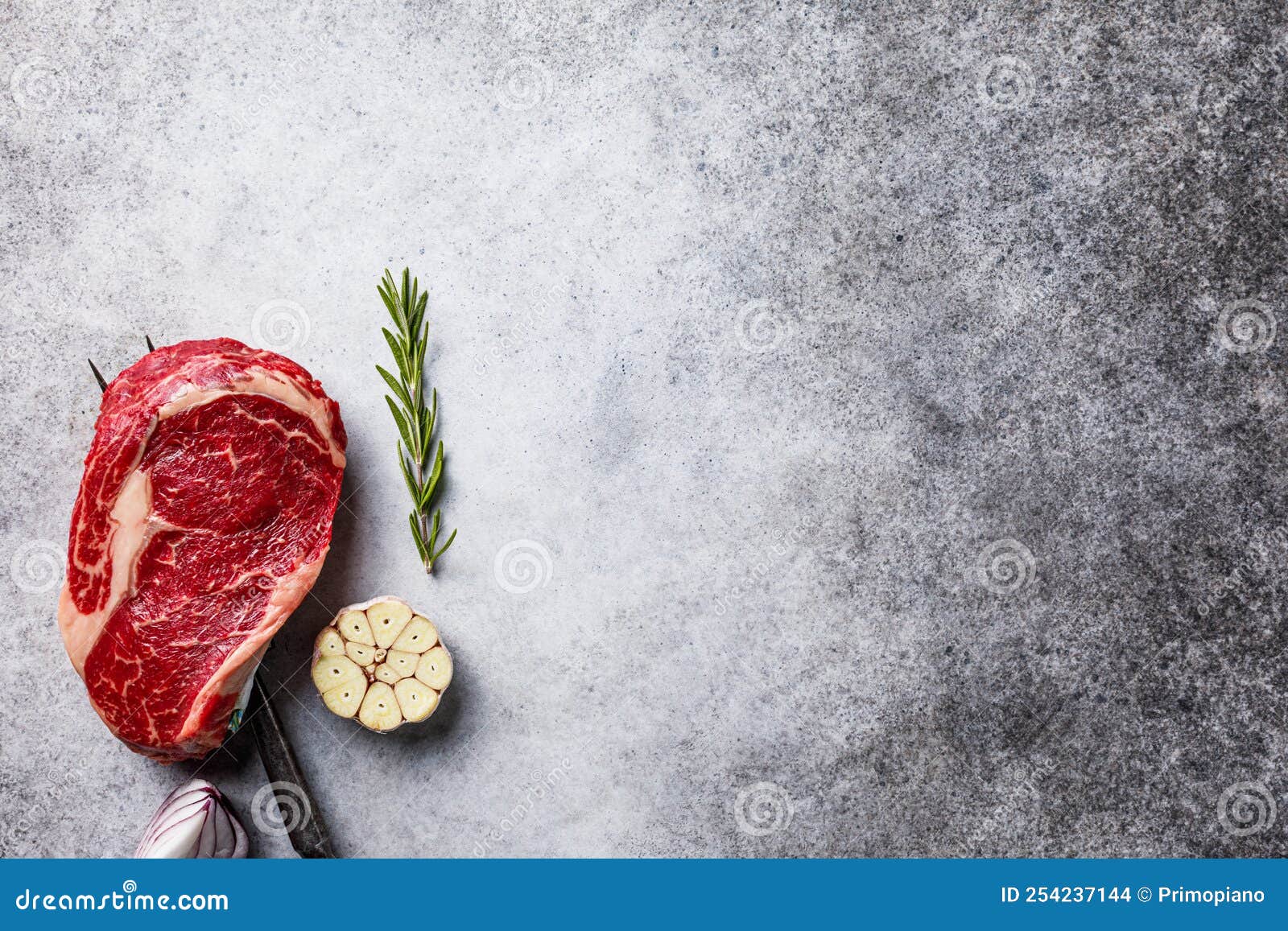 Fresh Raw Beef Ribeye Steak on Fork with Spices on Stone Board Stock ...