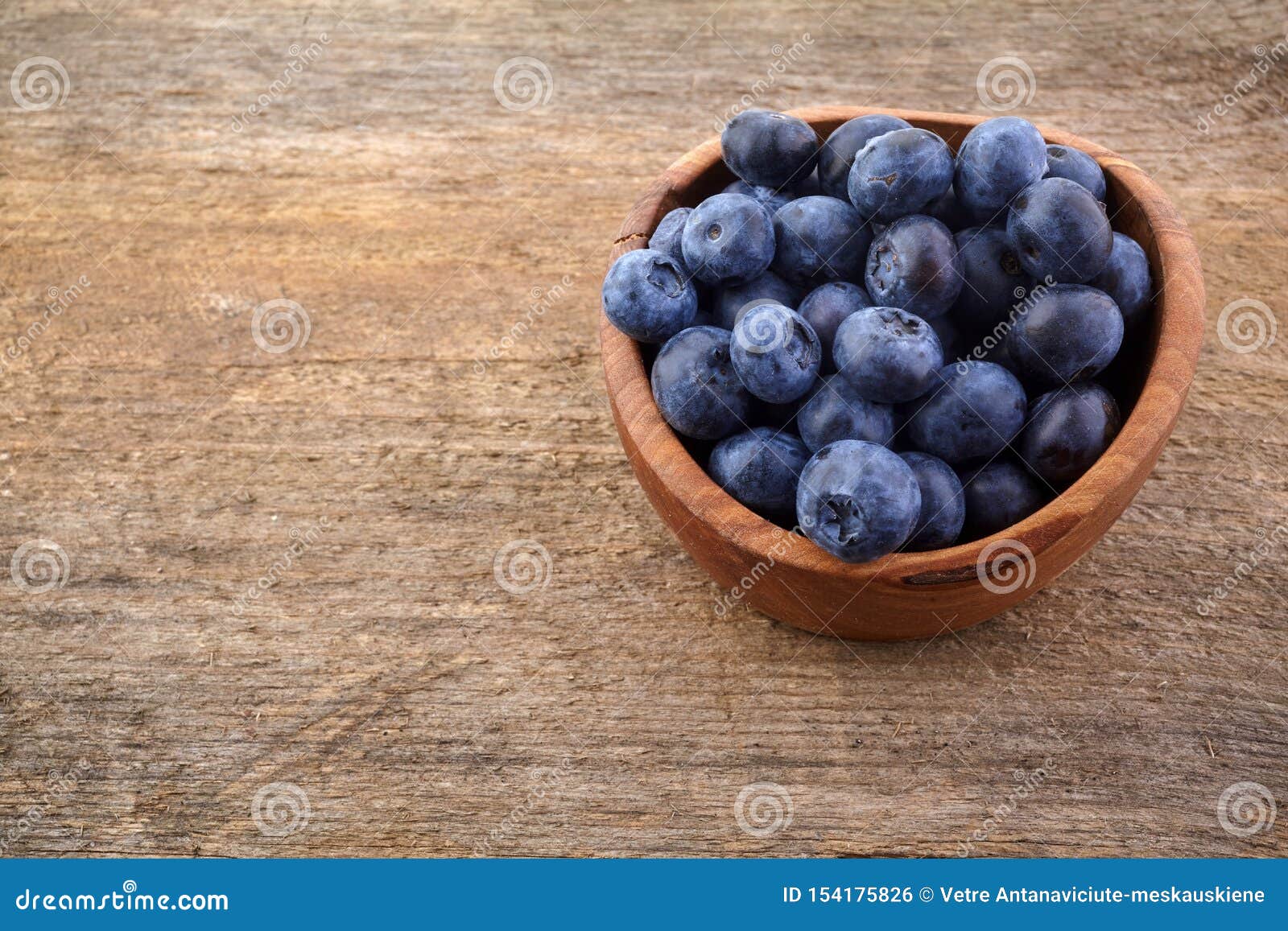Fresh Raw Blueberries in the Bowl on a Wooden Table. Stock Photo ...