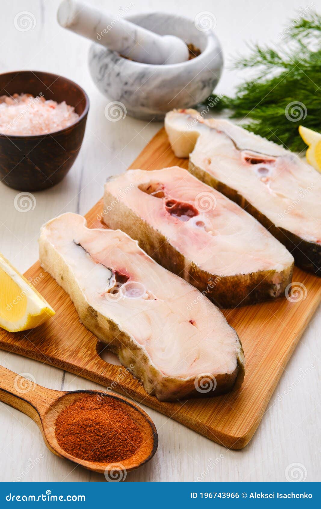Fresh Raw Cod Steak on Wooden Cutting Board with Spice Stock Photo ...