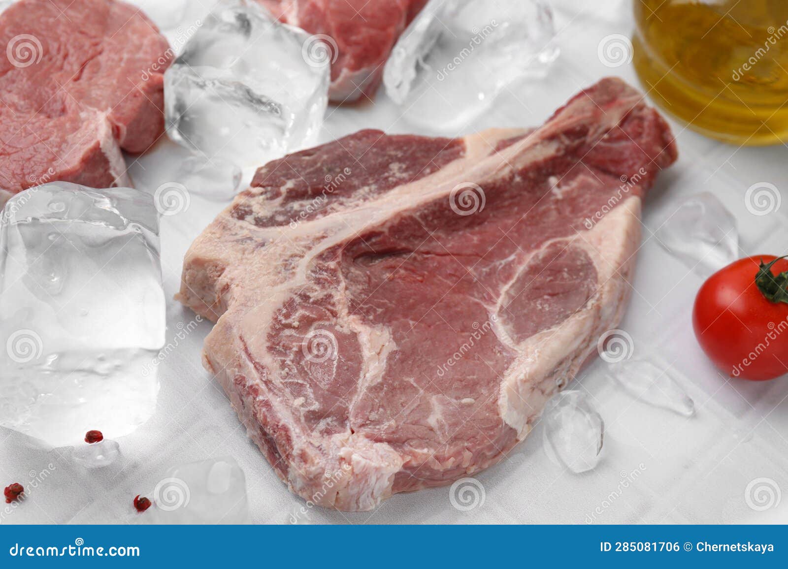 Fresh Raw Cut Beef and Ice Cubes on White Table, Closeup Stock Photo ...
