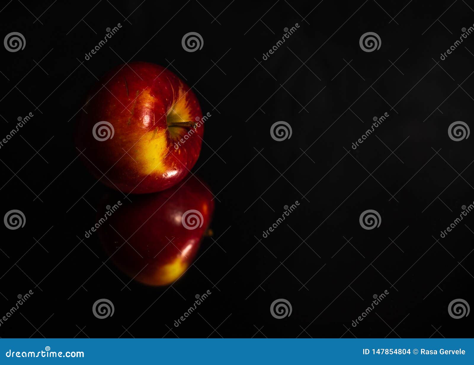Fresh Red Apple Reflection on Black Mirror Surface. Close Up Stock ...