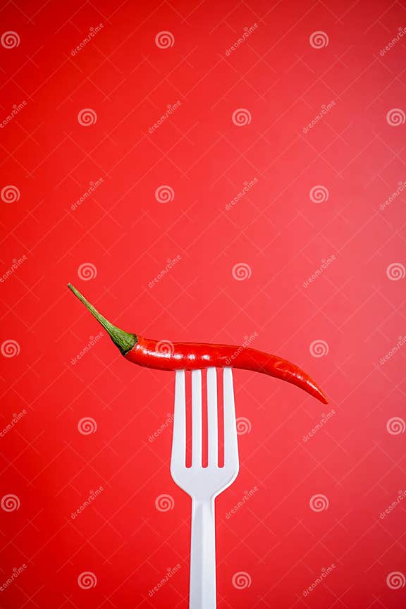 Red Chilli on White Plastic Fork with Red Background Stock Image ...