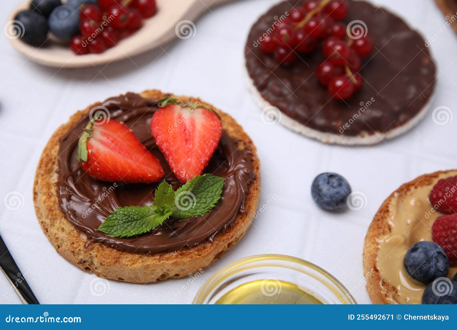 Fresh Rice Cake and Rusks with Different Toppings on White Table ...