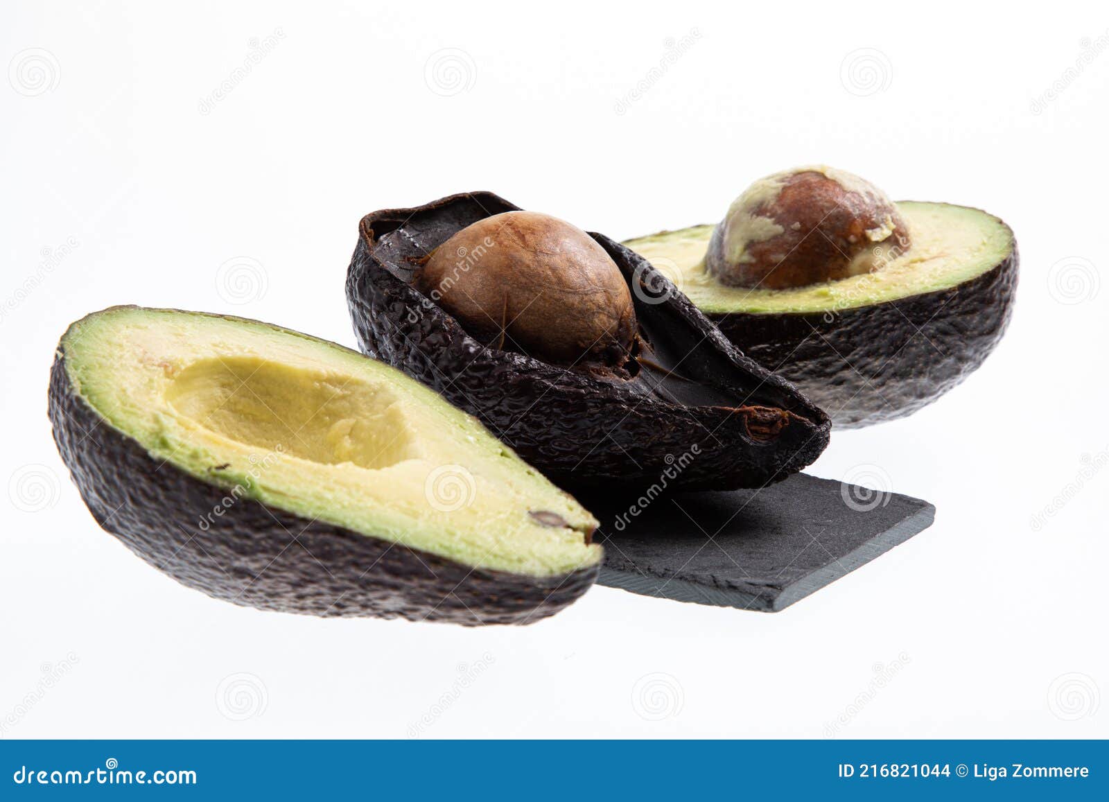Fresh and Ripe Avocado Next To Rotting Avocado Cut in Half with Seed ...