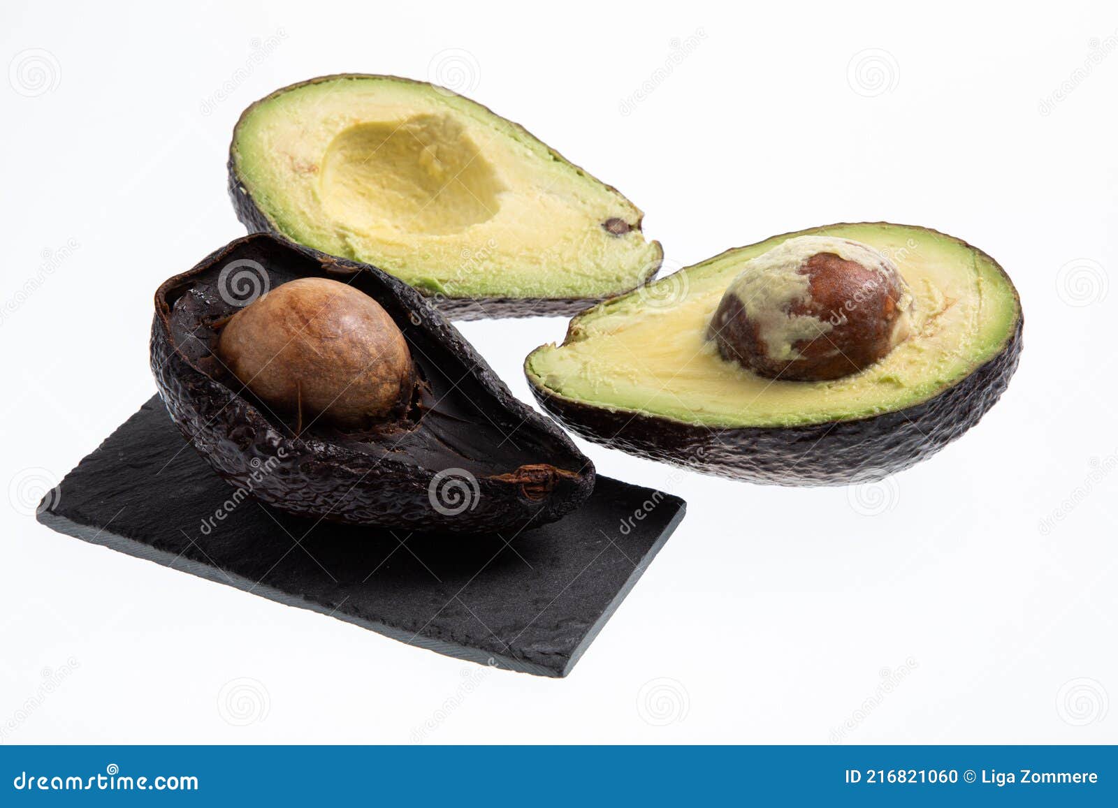 Fresh and Ripe Avocado Next To Rotting Avocado Cut in Half with Seed ...