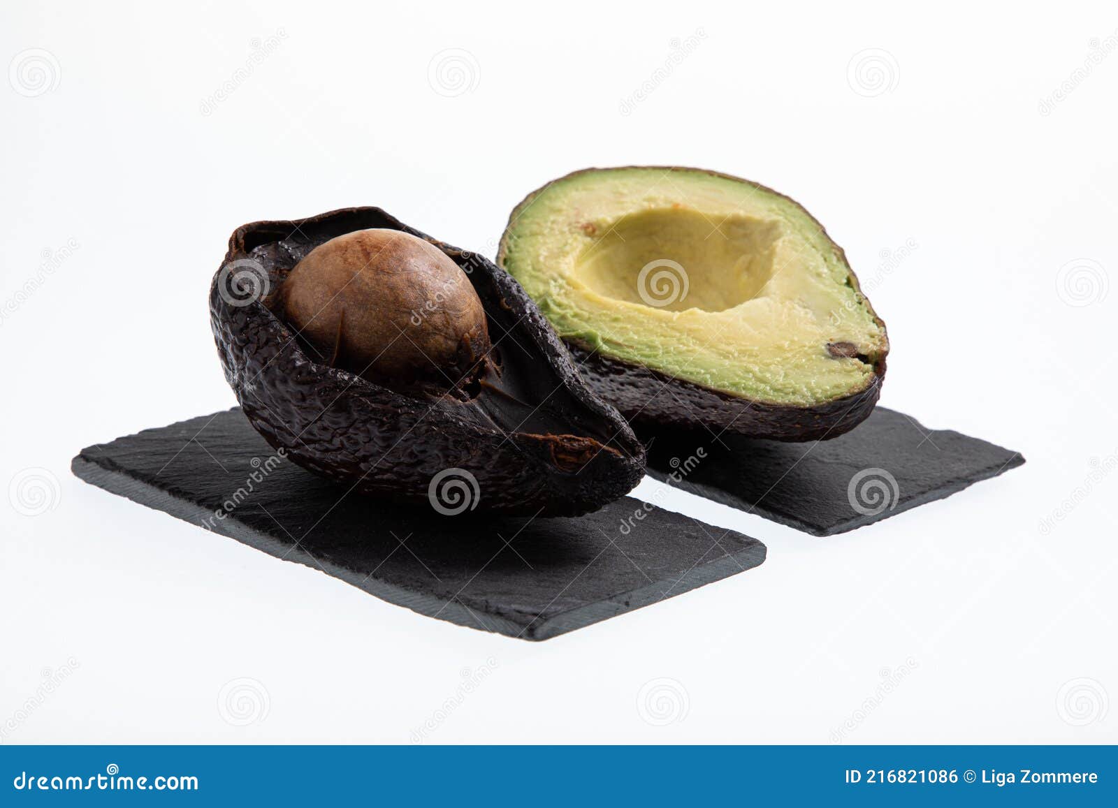 Fresh and Ripe Avocado Next To Rotting Avocado Cut in Half with Seed ...