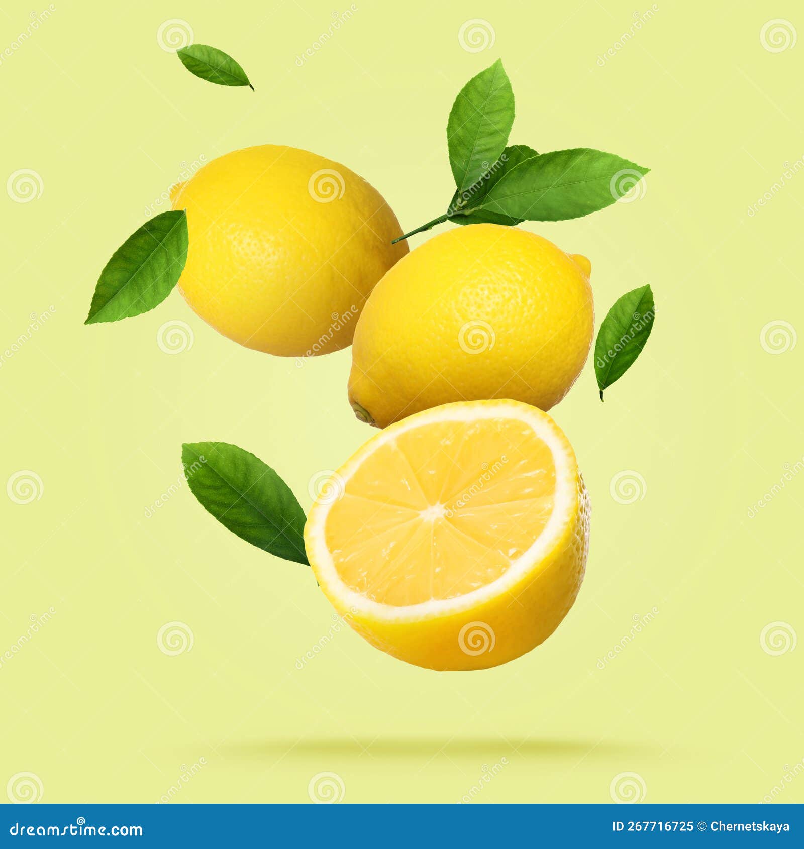 Fresh Ripe Lemons and Green Leaves Falling on Pale Light Green ...