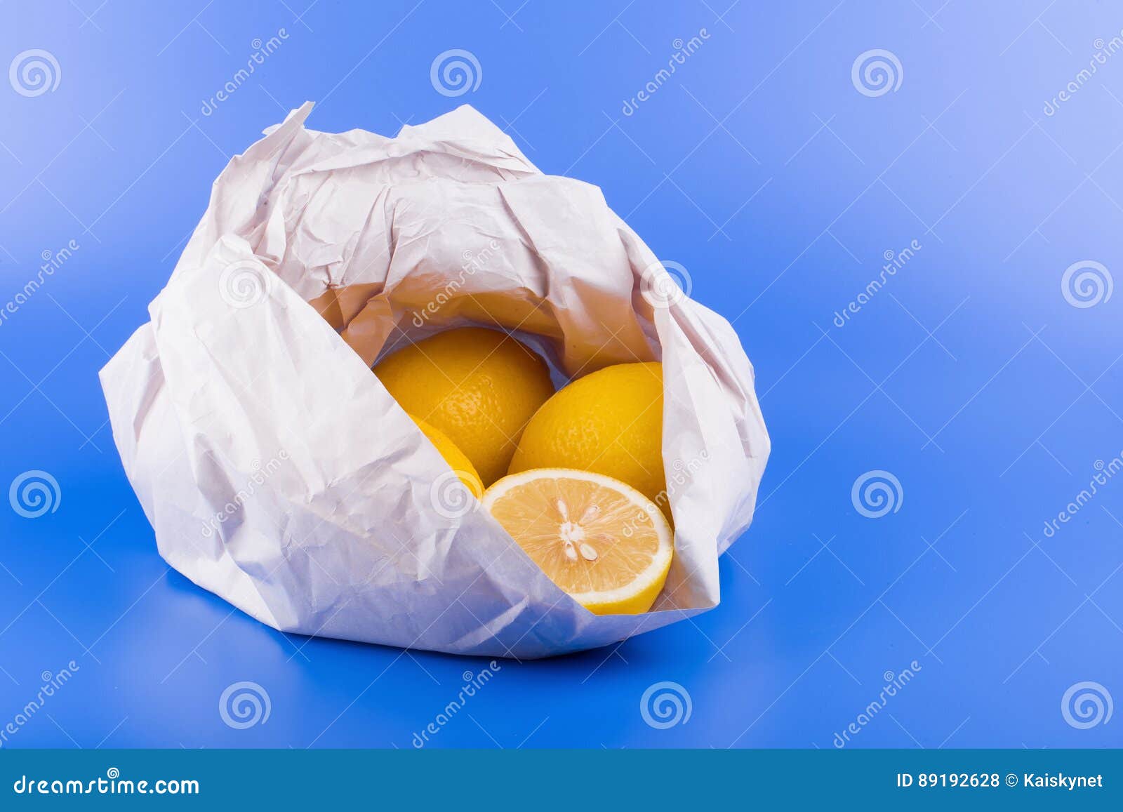 Fresh Ripe Lemons in Paper Bag on Blue Background Stock Photo - Image ...
