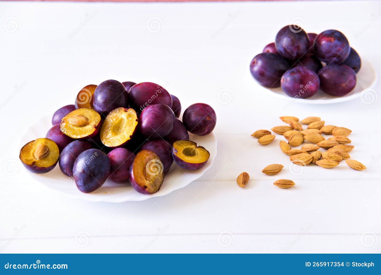 Fresh Ripe Plum Cut in Half in a Plate with Pits. Stock Photo - Image ...