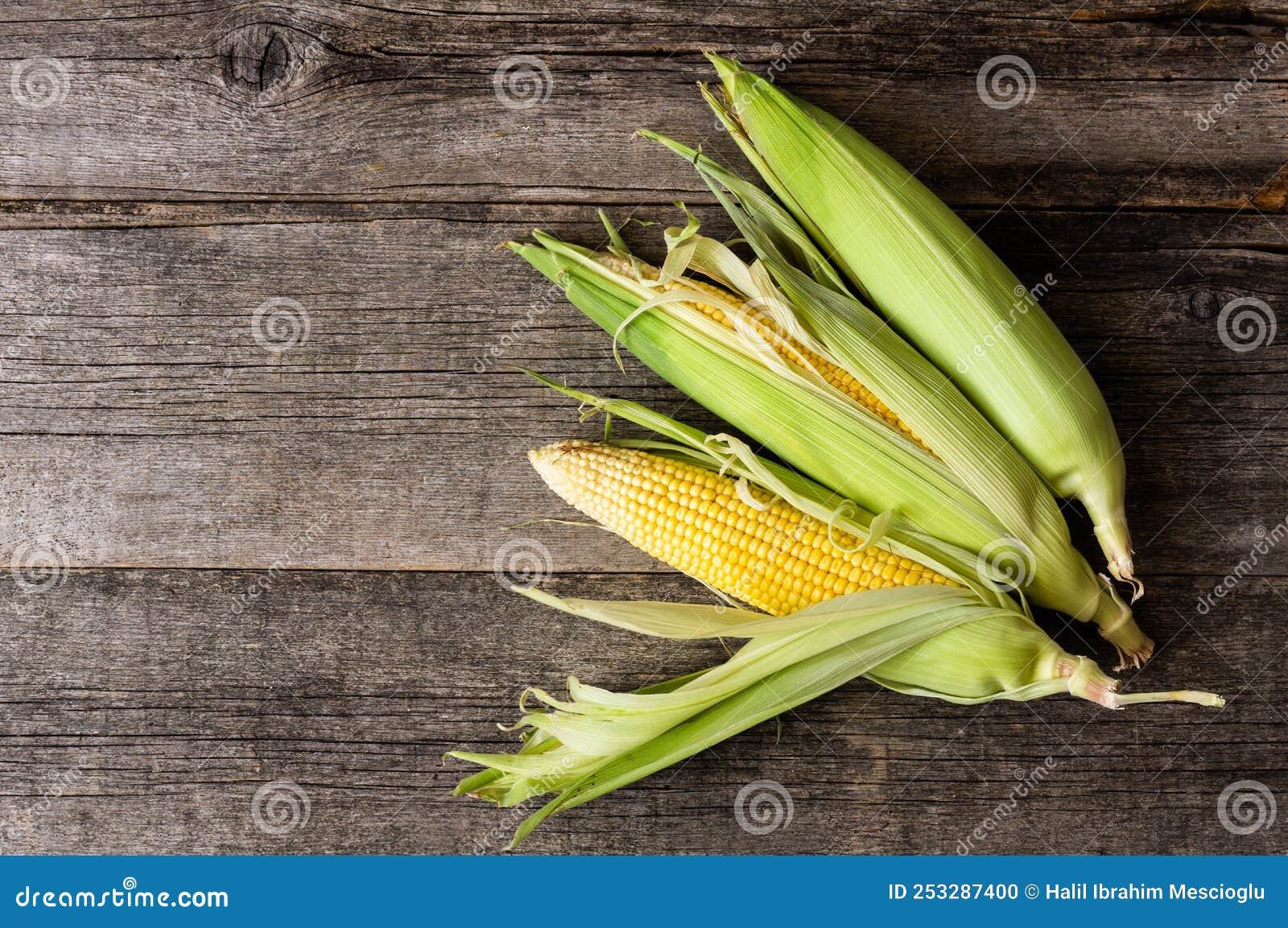 Fresh Ripe Three Half Peeled Corn Cobs on Rustic Table Stock Photo ...