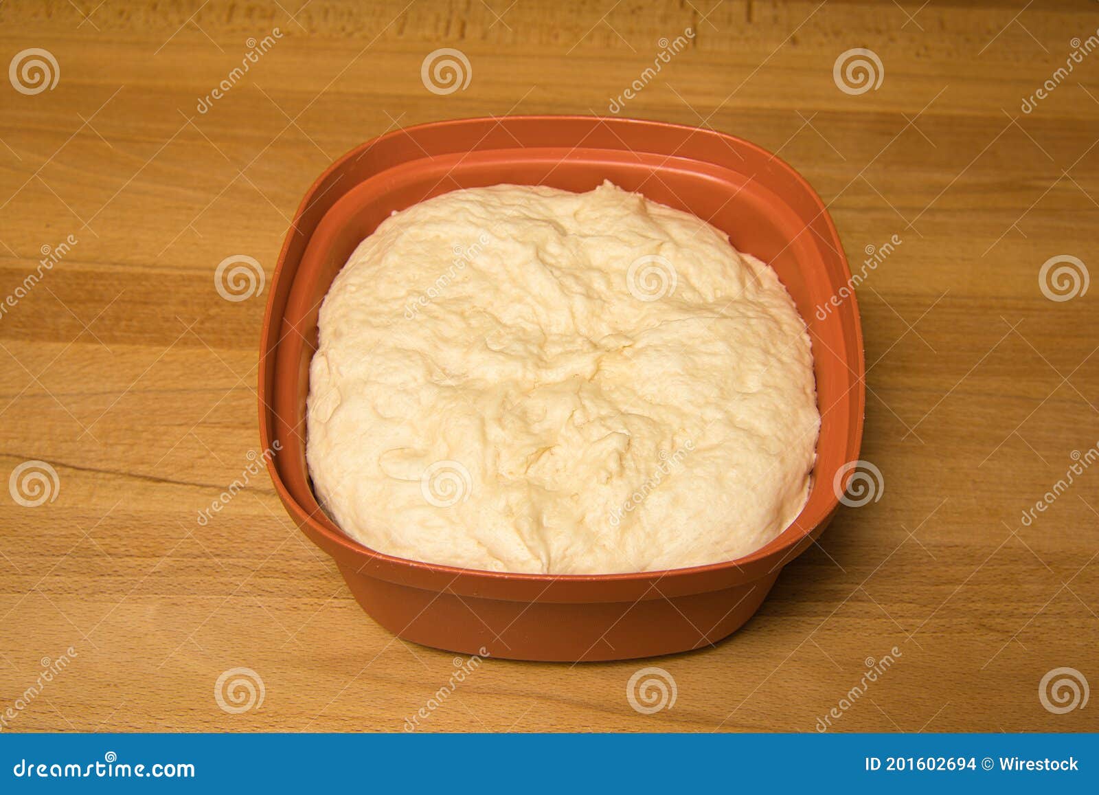 Fresh Risen Yeast Dough in a Red Bowl on a Wooden Table Background ...